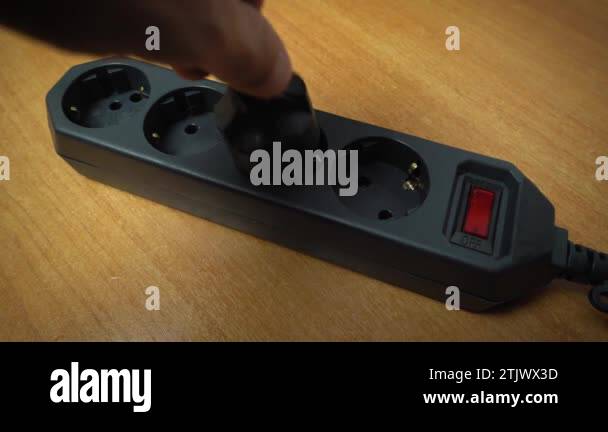 Insert plug into extension cord socket by pressing red push button ...