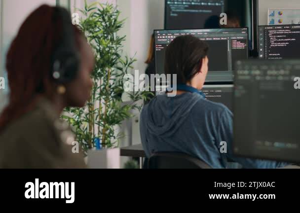Database Programer Writing Code On Terminal Window Using Multiple Monitors In It Agency Office