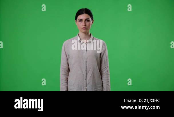A female hand appears on a green screen background making the universal ...