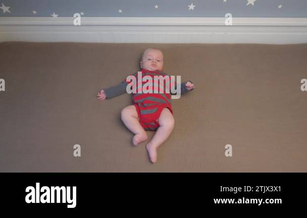 Mother dressing her 3 month old baby boy. Process of dressing little ...