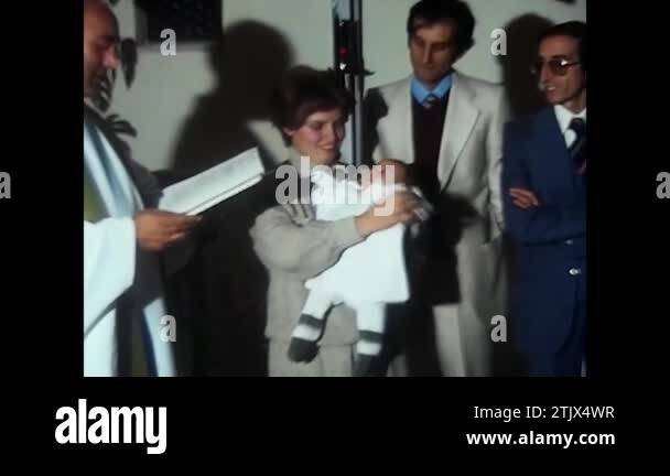 trento , italy april 1970: a priest who celebrates a baptism ceremony ...
