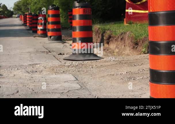 rack focus long line row of orange and black traffic delineator pylon ...
