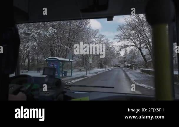 View from a drivers side of a city bus on a snowy street in Munich ...