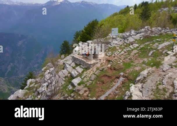 Aerial video of a family of tourists visitng the Grlo Sokolovo canyon a ...