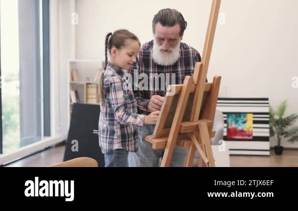 Close up view of senior grandfather and little child in similar outfits ...