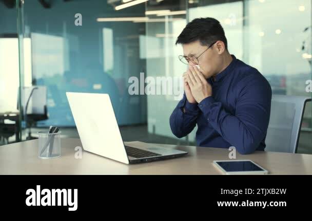 Sick businessman IT programmer blowing running nose sneeze and cough ...