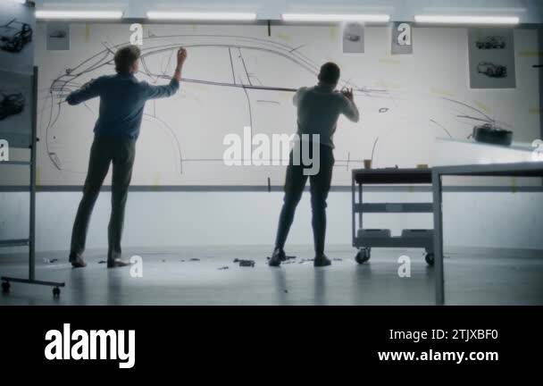Two diverse automotive male designers drawing sketch with marker on ...