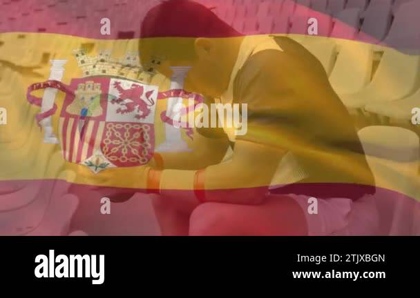 Animation of spanish flag waving over sad caucasian male player sitting ...