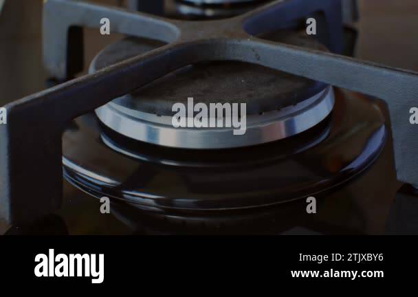 A fire ignites in the burner of a gas stove. Fragment of a gas kitchen ...