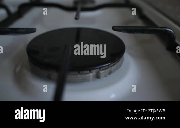 Ignite gas in a burner on a gas stove. Slow motion Dolly shot. Close-up ...