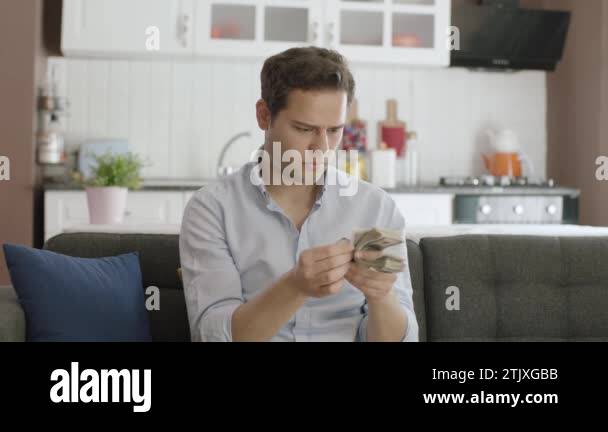 The young man is very happy with his money.Winning the online lottery ...