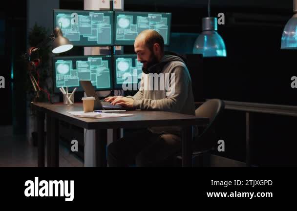 Aggressive angry criminal trying to hack network at night, feeling mad ...