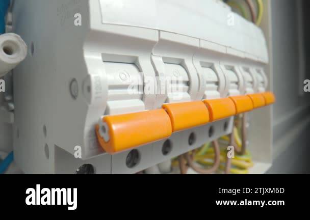 Circuit breaker switching. Close up of finger switching off high ...