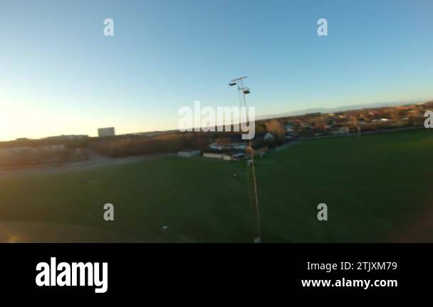 Drone flight above a lightpost before racing under the goalpost of a ...