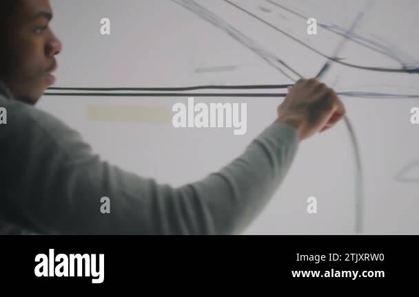 African American automotive male designer creating sketch with duct tap ...