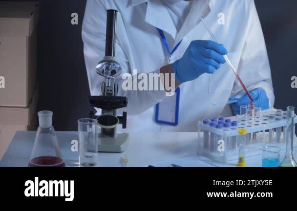 Pathologist working in lab with blood samples. Scientist processing DNA ...