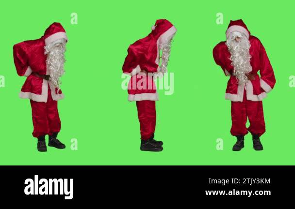 Old santa suffers from back pain in studio, feeling unwell standing ...