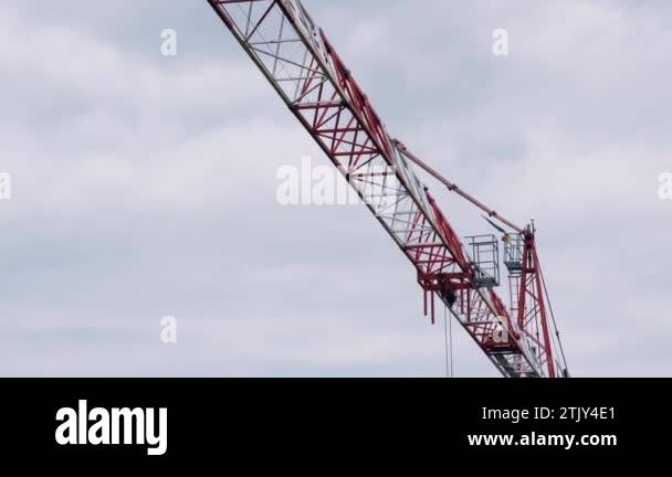 High crane works on building site with house. Crane tower in ...