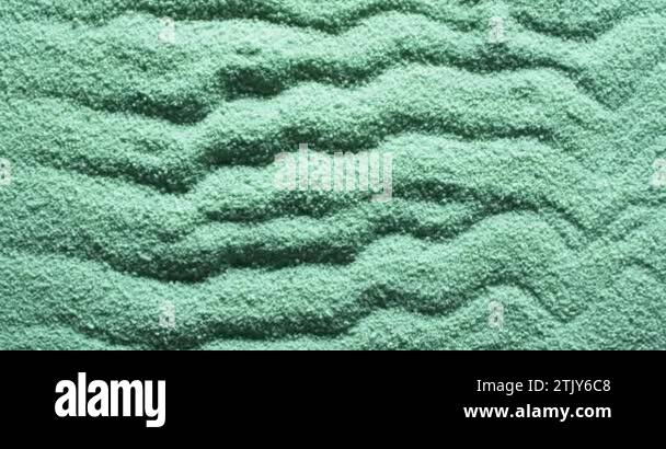Video of close up of green coloured sand with pattern and copy space ...