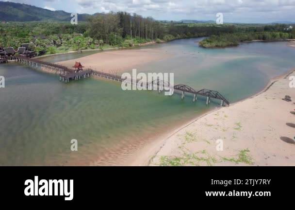 A bridge between two beaches near the ocean. Shallow water. The clear ...