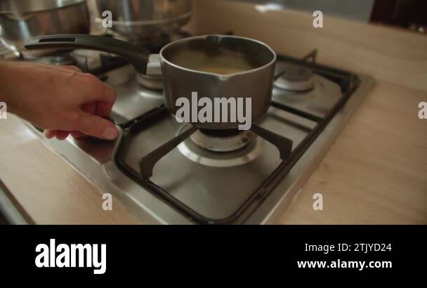 COOKING ON THE GAS STOVE | MODELS HANDS PLACES THE VESSEL ON THE GAS ...