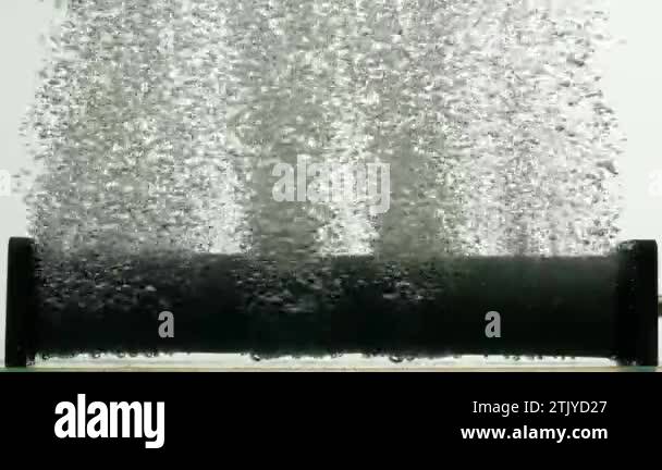 Stream of air bubbles escaping from dark paralon tube of compressor or ...