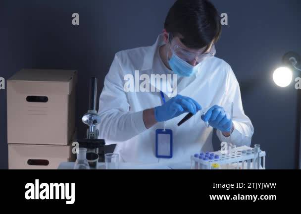 Health care worker with blood test tubes in clinical laboratory ...