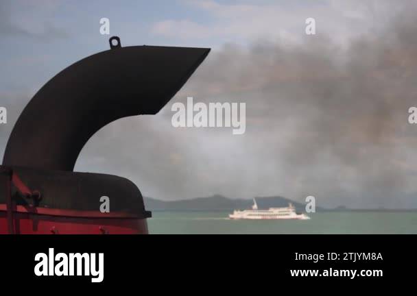 Black smoke from ferry boat flue in background, close up, Thailand ...