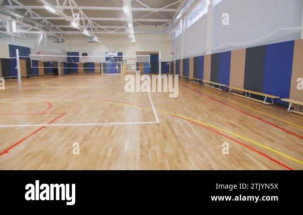 Large sports hall for games in educational institution. Wooden benches ...