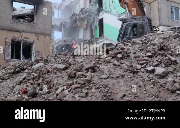 Excavator with hydraulic crusher at the demolition of a residential ...