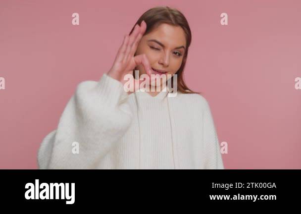 Ok. Joyful happy one woman in sweater looking approvingly at camera ...