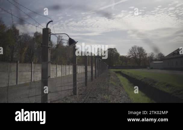 Details of the prison wall. Barbed wire and a lantern. Camp for ...