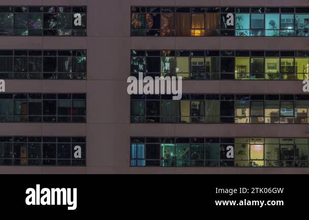 Windows lights in modern apartment buildings timelapse at night. Multi ...