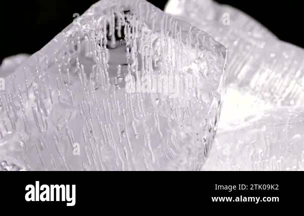 Pieces of ice with frozen air bubbles shine through with light. Frozen ...