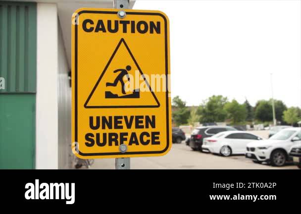 caution uneven surface sign with caption and illustration picture of ...