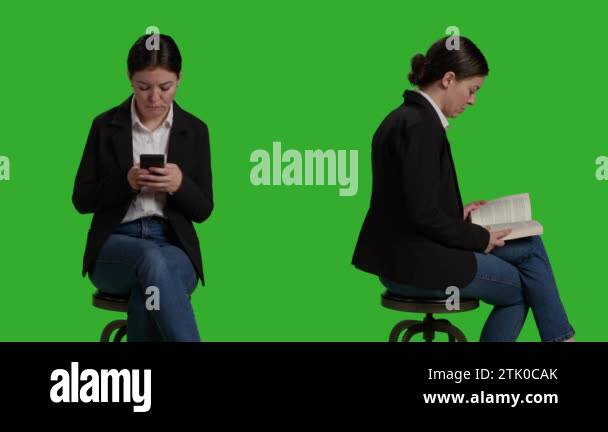 Close up of manager reading book and texting messages on camera ...