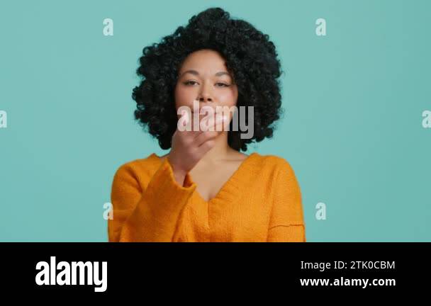 Young beautiful African American girl thoroughly thinking out an idea ...