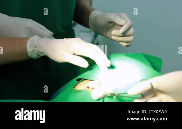 Hands of surgeon doctors and cosmetic surgery team assistant work using ...