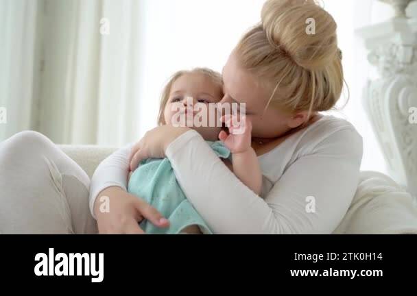 Mother embrace baby girl at home. Family love in bedroom. Happy ...