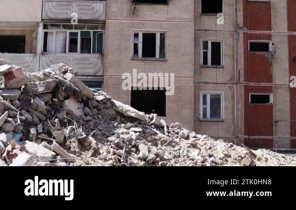 Excavator with hydraulic crusher at the demolition of a residential ...