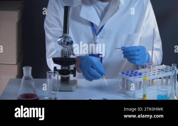 Health care worker with blood test tubes in clinical laboratory ...