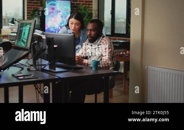 Creative agency employees using computers to develop new graphics ...