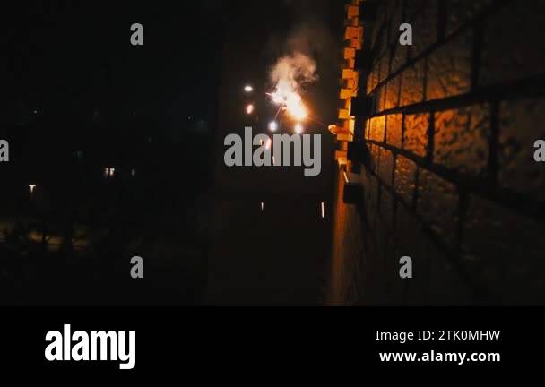 Fireworks and sparklers burn sprinkle sparks on the street from the ...