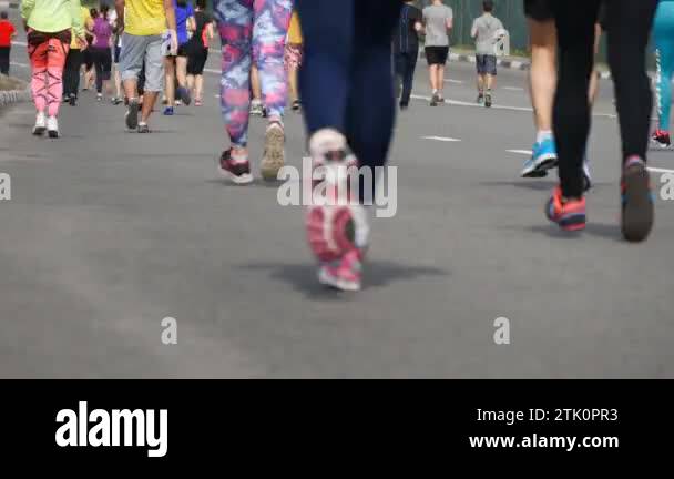 City marathon. Feet of people. Legs of runners on the city street ...