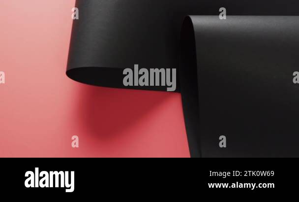 Close up of rolls of black paper and copy space on red background ...