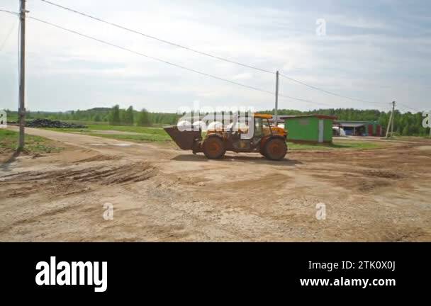 Tractor with scoop Stock Videos & Footage - HD and 4K Video Clips - Alamy