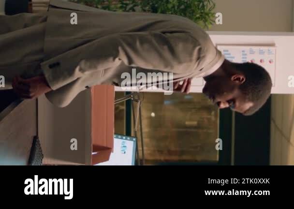 Vertical video Upset employee leaving modern office after deciding to ...