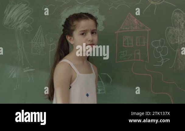 The little girl is upset that she can't solve the problem on the board ...