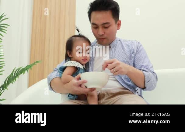 Father raising daughter at home : Happy father shot sitting on the ...