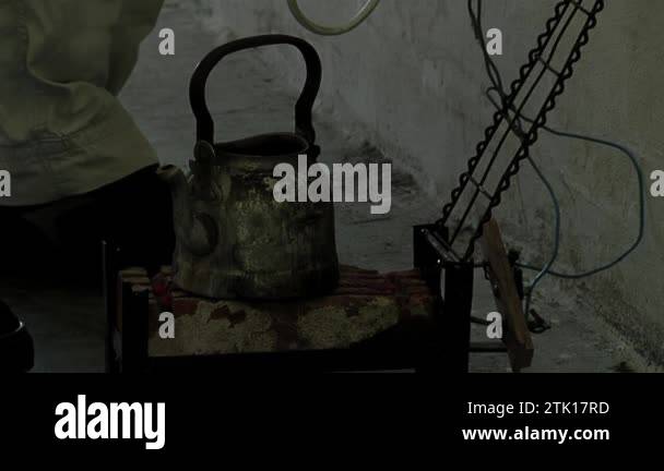 Inmate Heating Water on Rustic Electric Stove inside a Maximum Security ...
